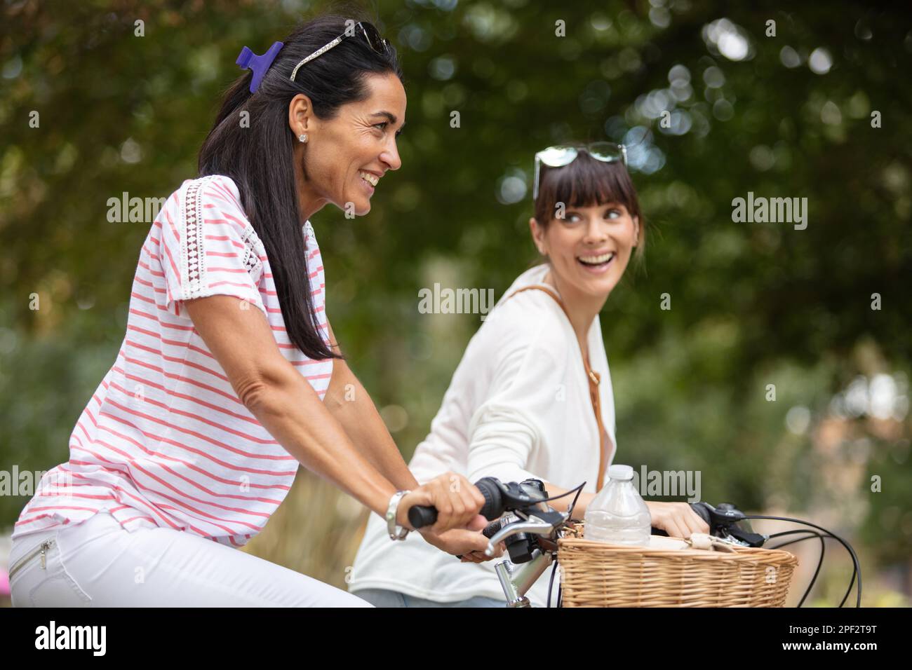 two beautiful women having fun cycling Stock Photo - Alamy