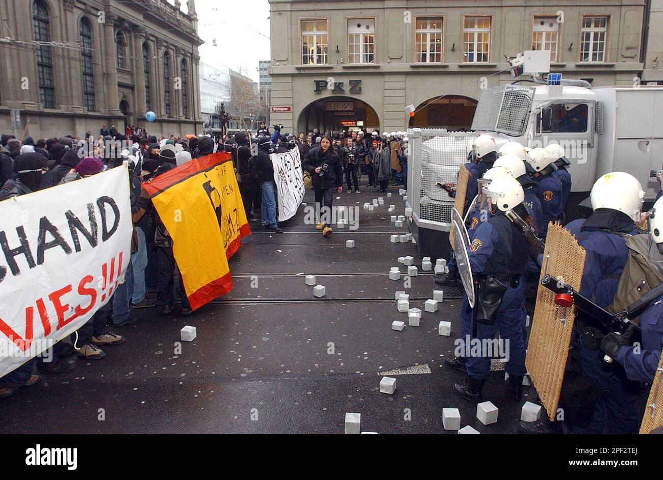 Anti-WEF demonstrators and riot police officerrs stand face to face in ...