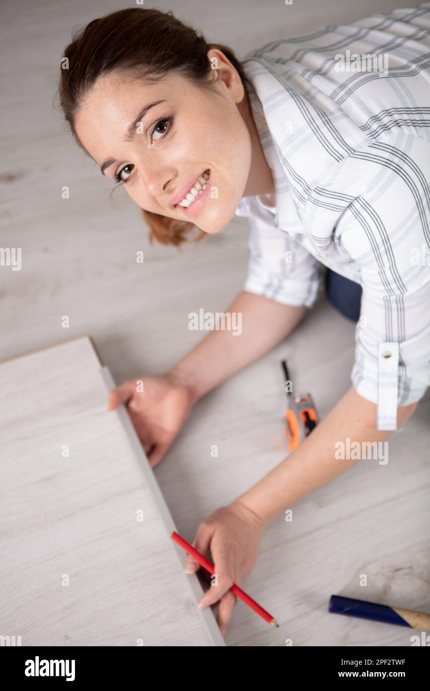 Woman laying laminate hi-res stock photography and images - Alamy