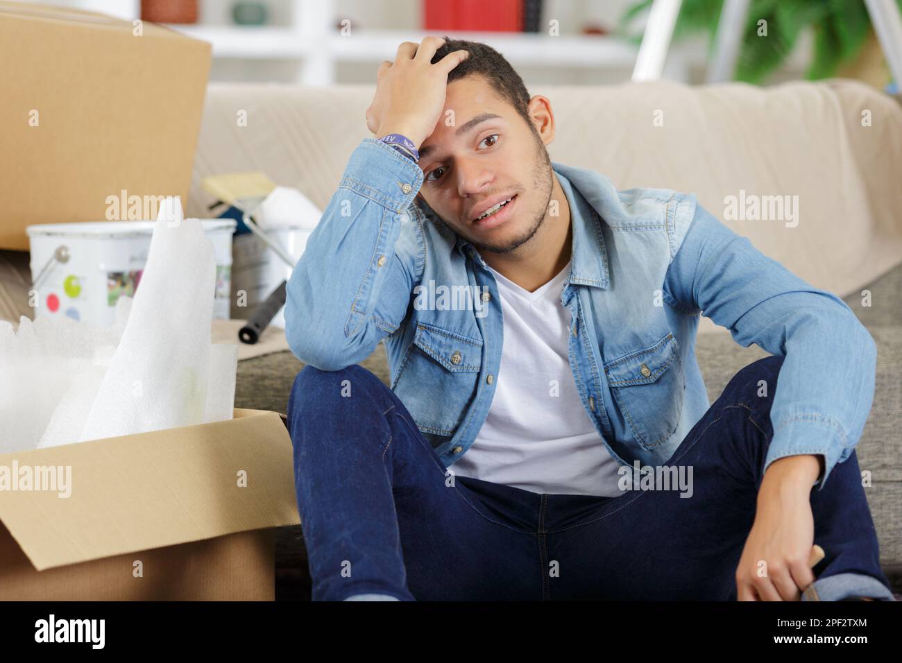man in between boxes indoors Stock Photo - Alamy