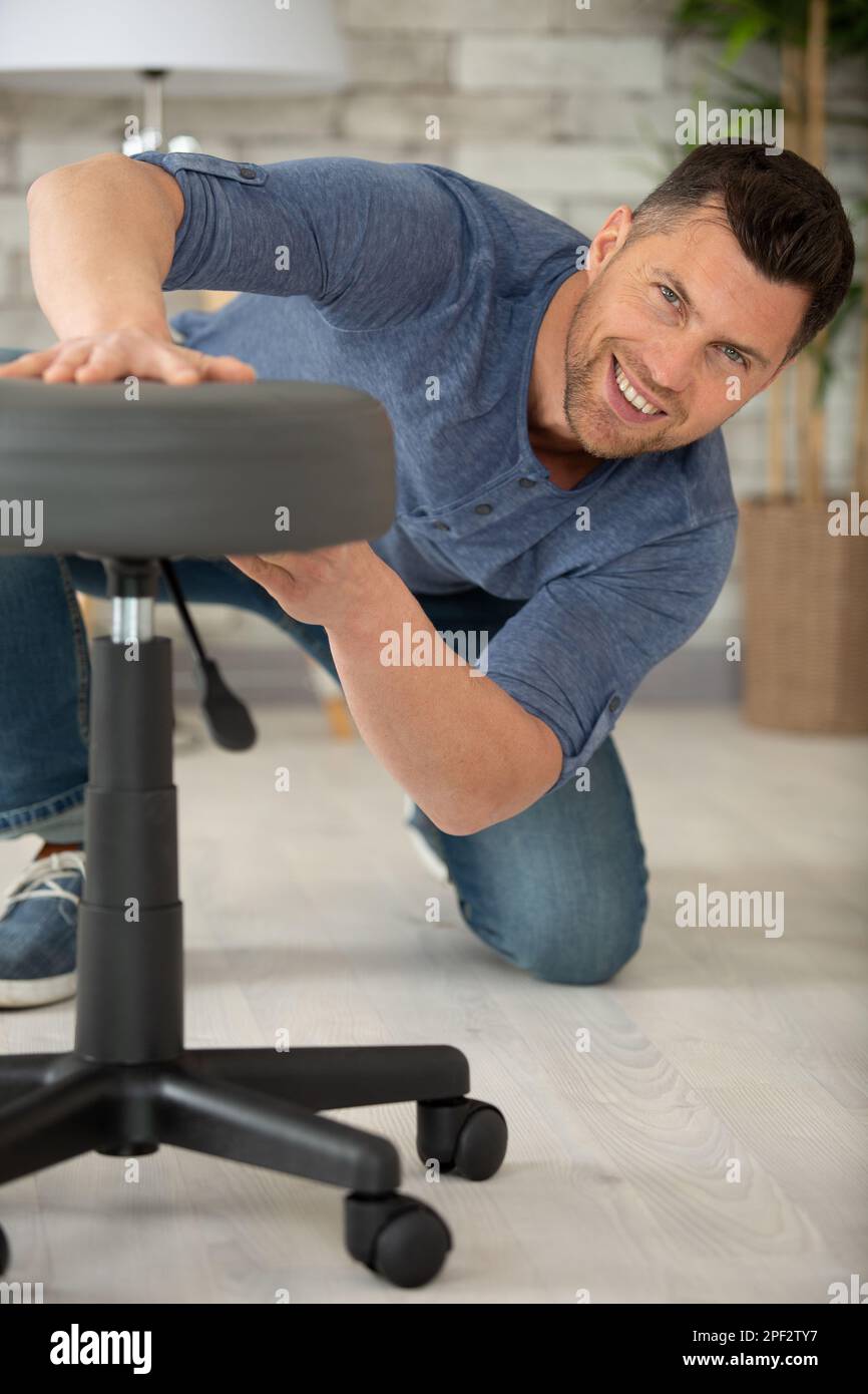 Person fixing an office chair hi-res stock photography and images - Alamy