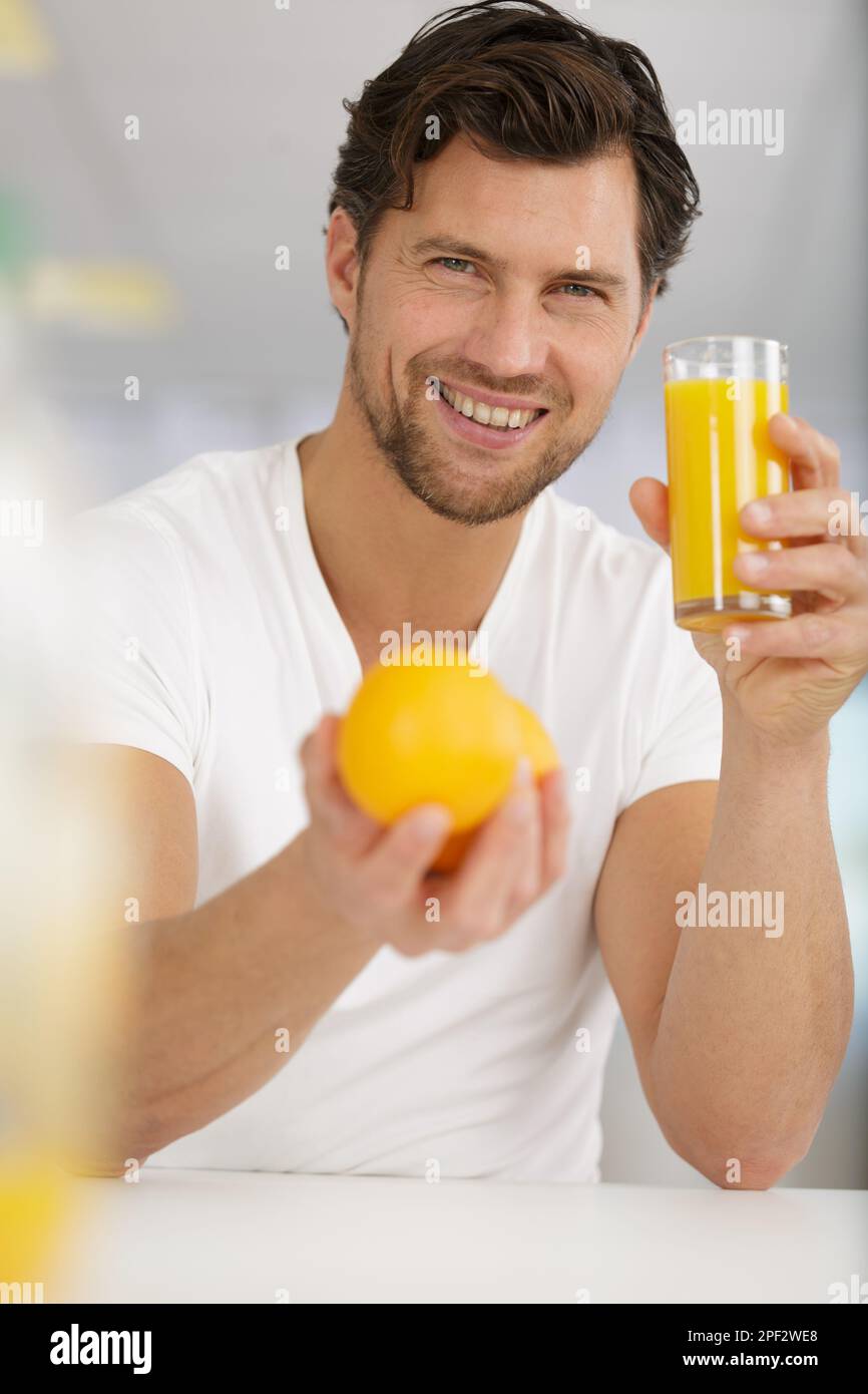 Holding glass milk orange juice hi-res stock photography and images - Alamy
