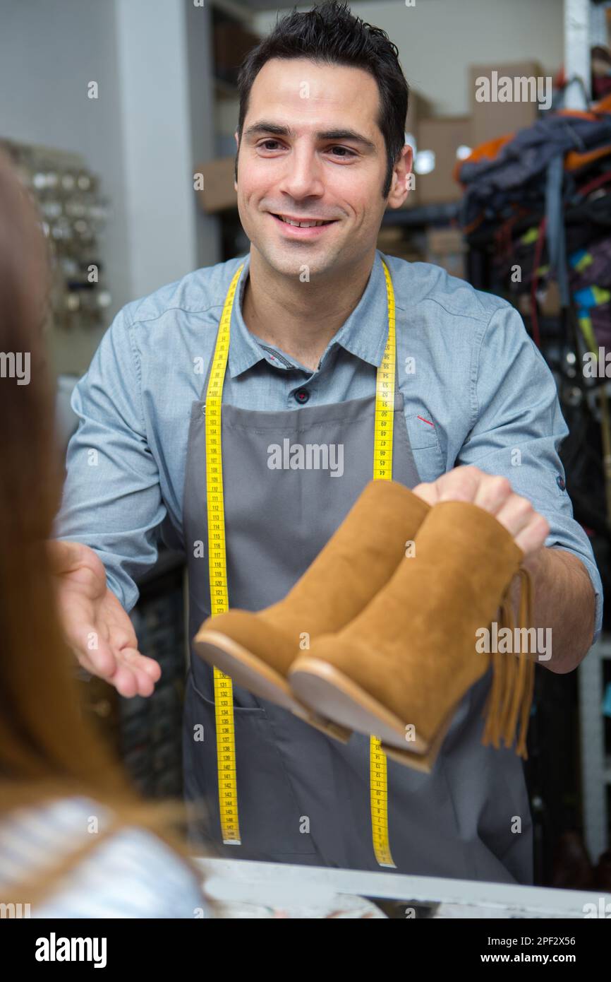 young shoemaker in workshop making shoes Stock Photo - Alamy