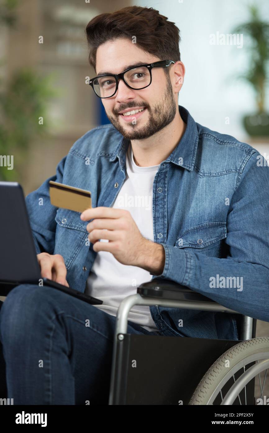 disabled person reads credit card and uses pc Stock Photo - Alamy