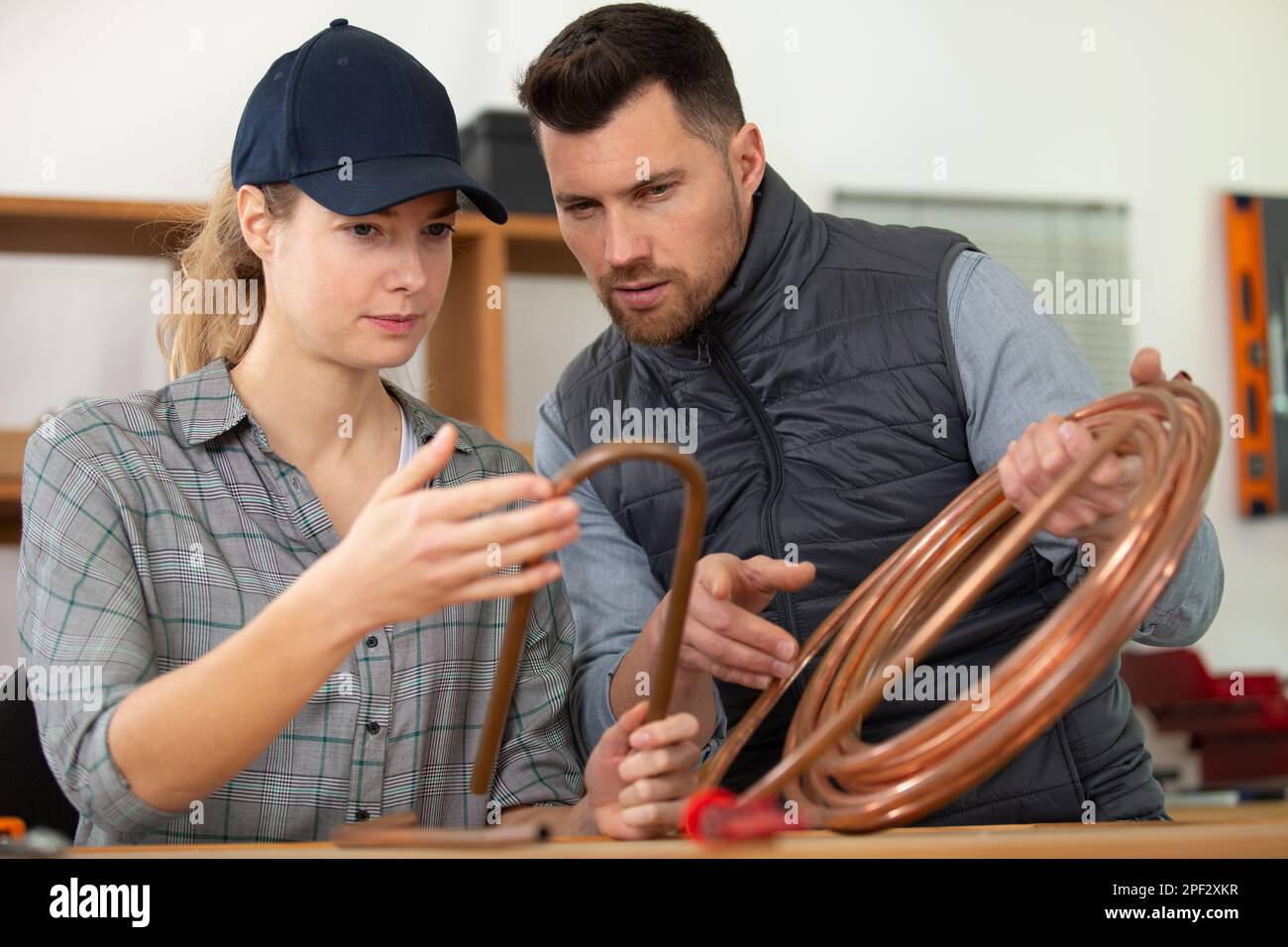 couple of plumbers at work with copper pipes Stock Photo - Alamy