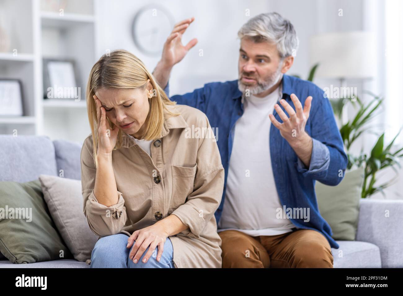 Family conflict quarrel, man shouting and upset woman close-up, couple ...