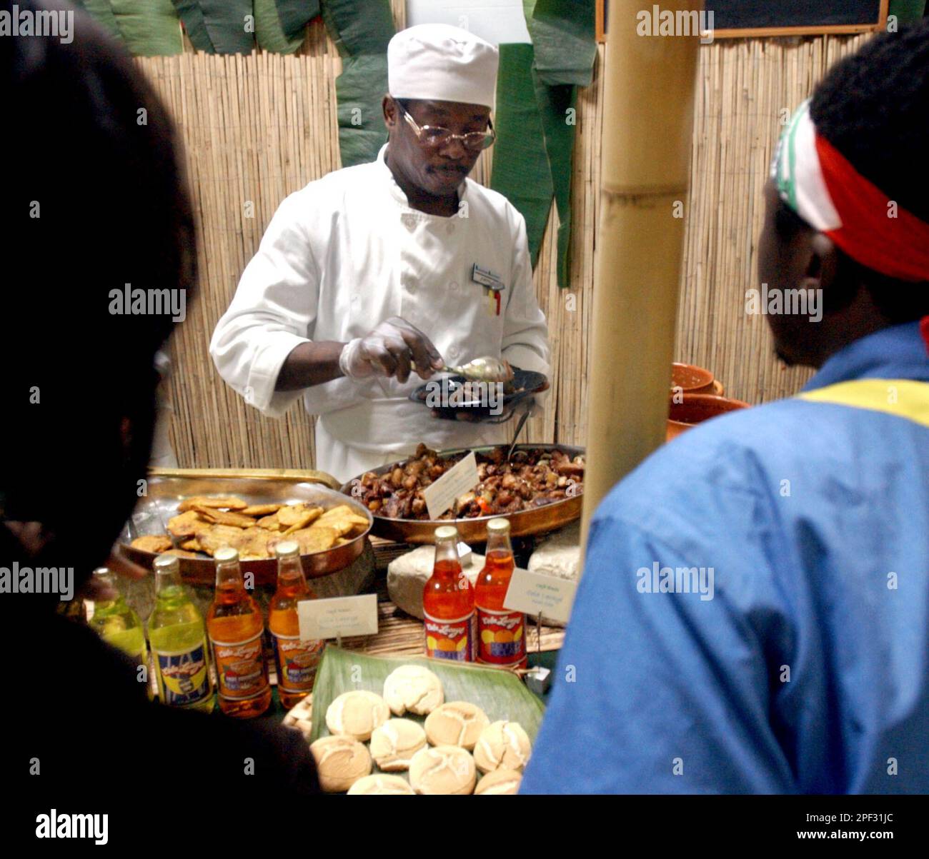 Haitian chef Joseph Cazeau serves a sampling of Haitian cuisine during ...