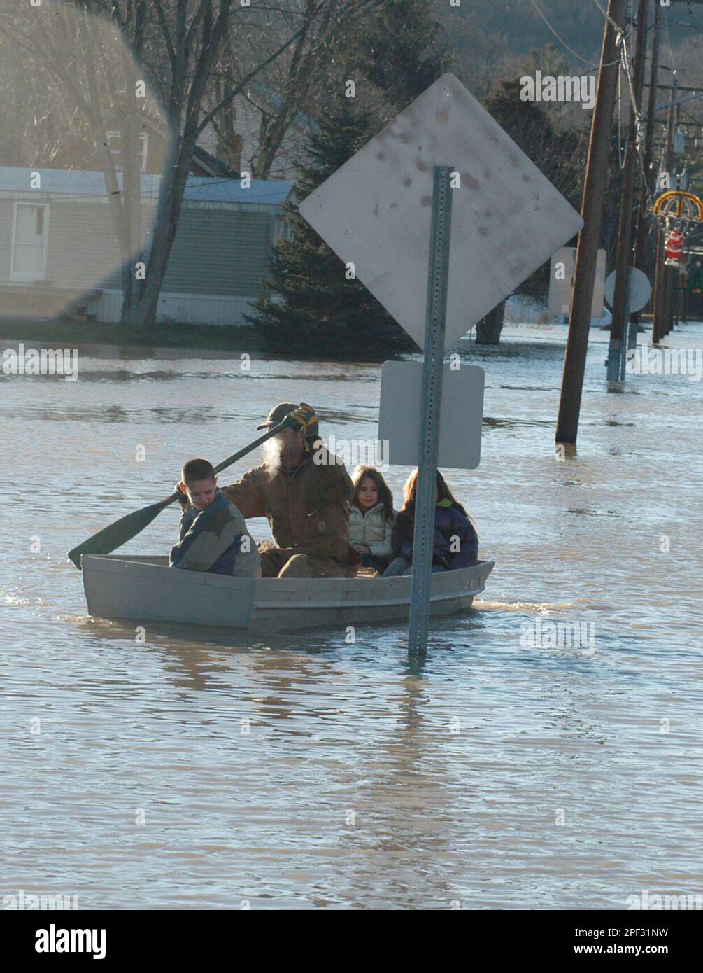 Robert Westerviller of Chauncey, Ohio, paddles a boat containing three ...
