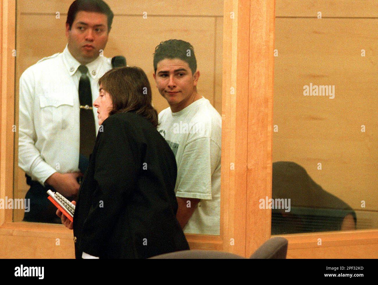 William Ayala, third from left, looks into courtroom, as Carlos ...