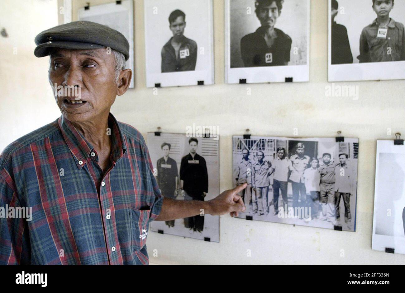 Chum Mey, 72-year-old former prisoner of the Khmer Rouge, points to a ...