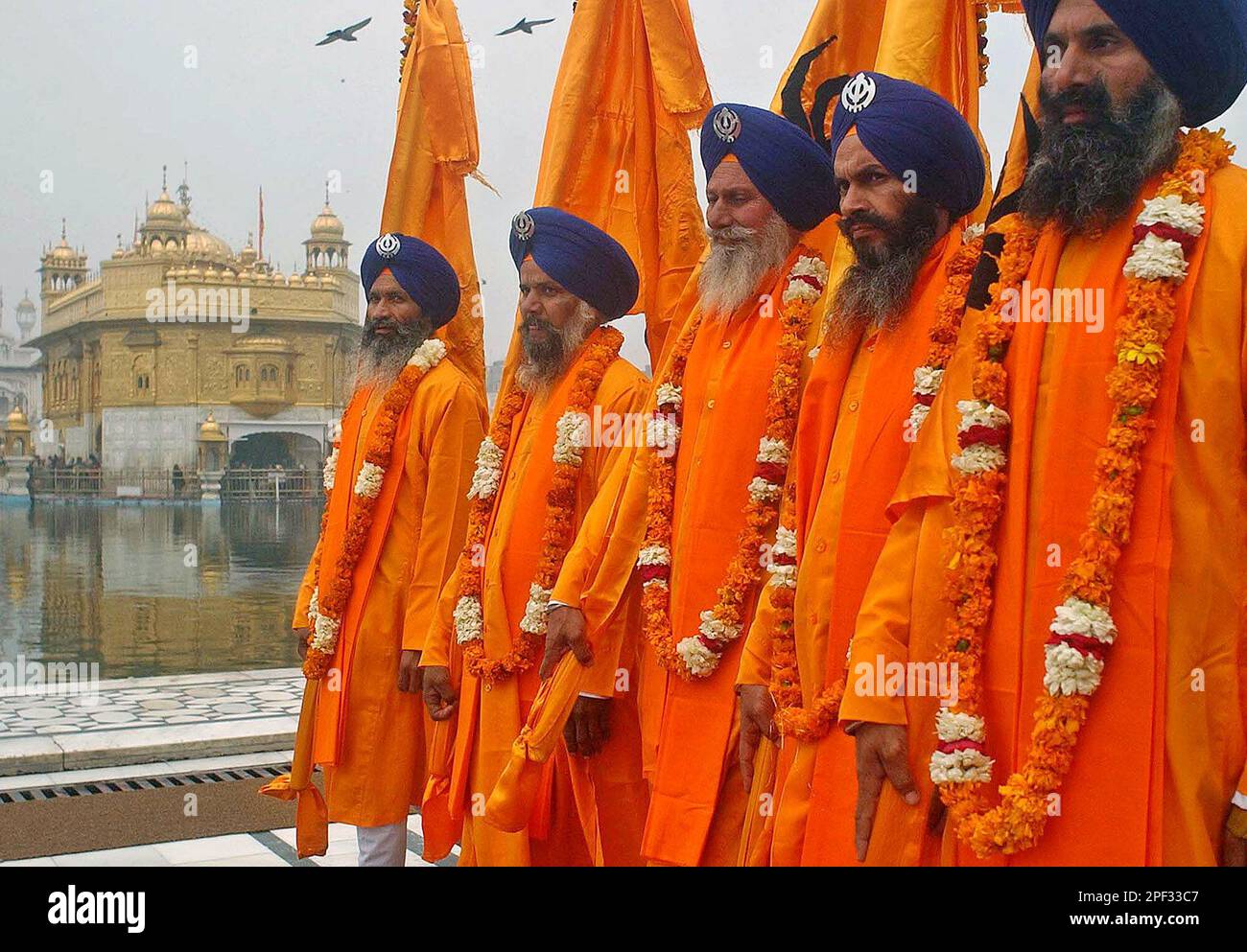 Baptized Sikhs lead a religious procession at the Golden Temple complex ...
