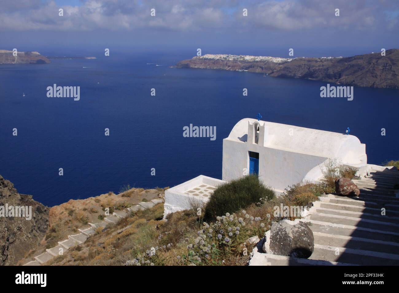 Santorini cliffside chapel caldera view Stock Photo - Alamy