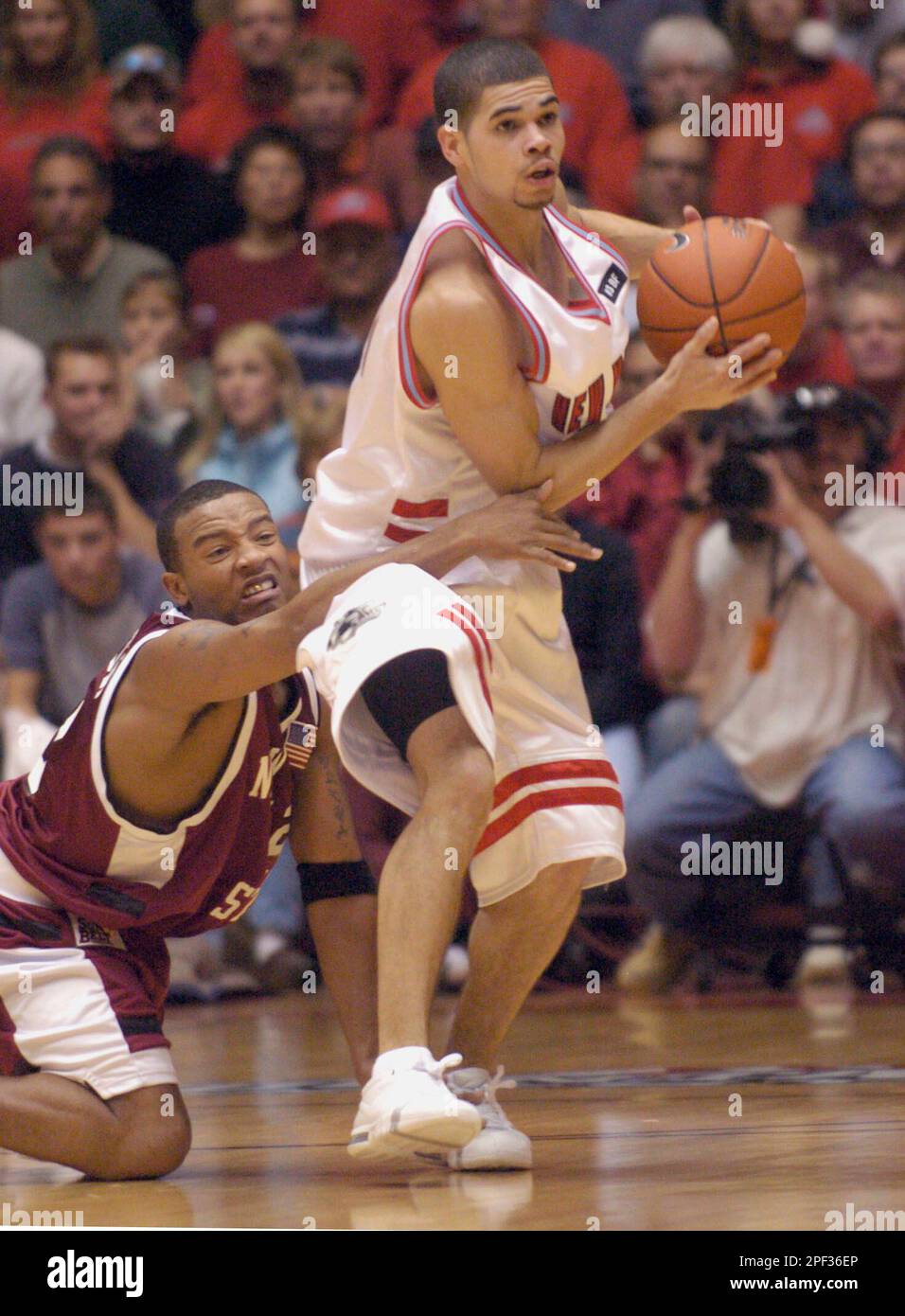 New Mexico State's Detrius Roberson, left, reaches for the ball as New ...
