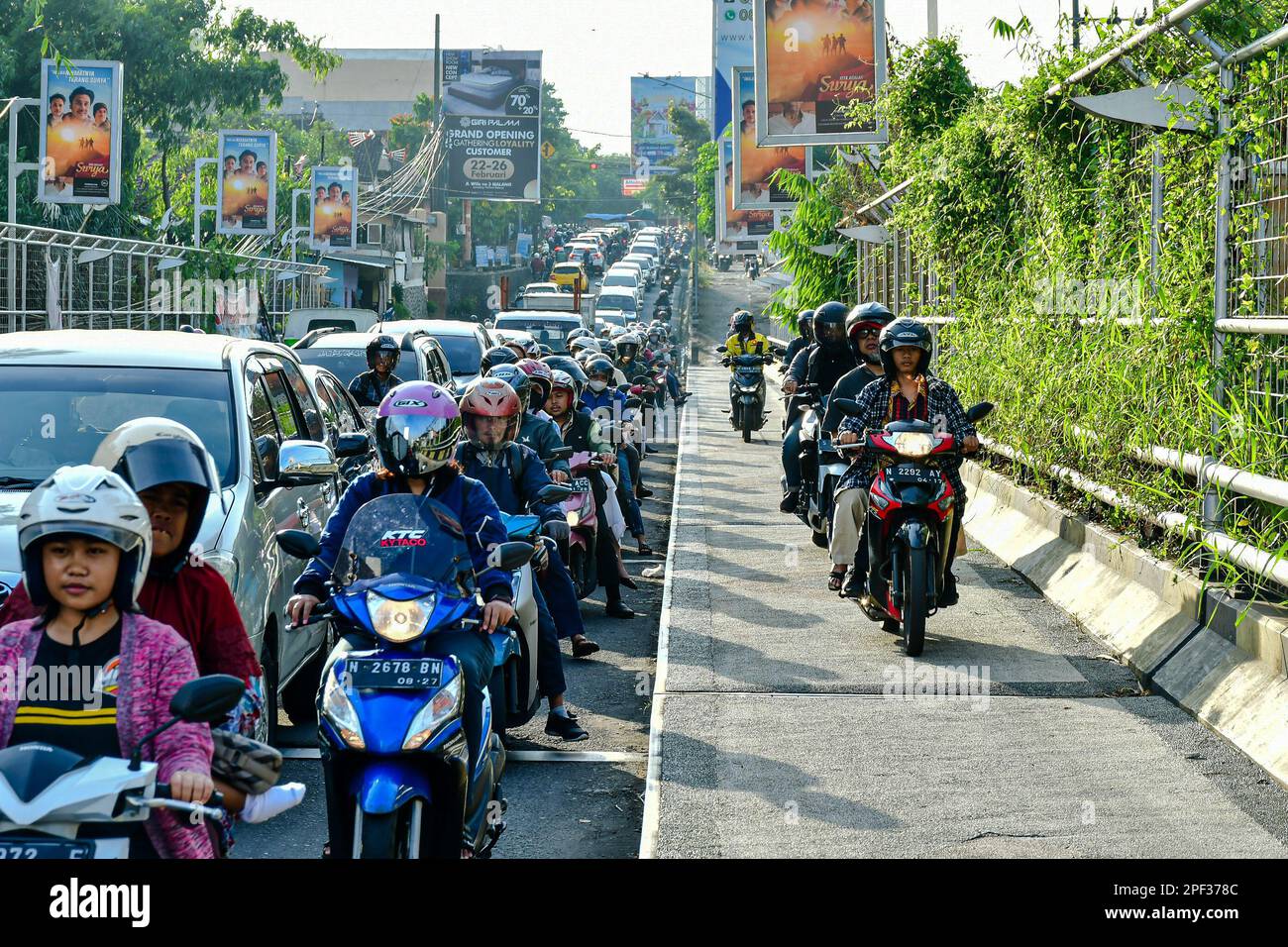Malang, East Java, Indonesia. 16th Mar, 2023. People stuck in traffic ...