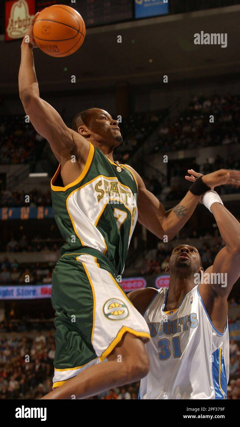 Seattle SuperSonics forward Rashard Lewis, front, flies over Denver ...