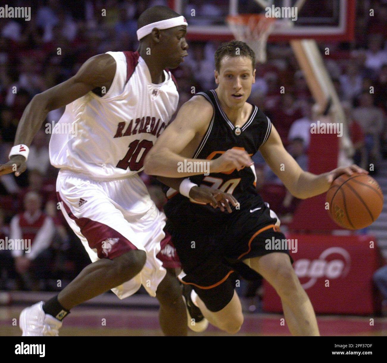 Oklahoma State's Daniel Bobik, right, drives around Arkansas' Ronnie ...