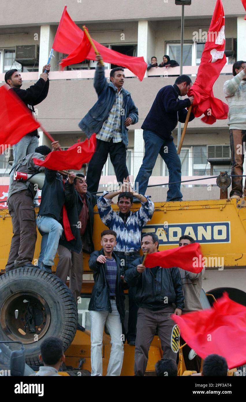 Members of the Iraqi communist party wave flags in celebration in ...