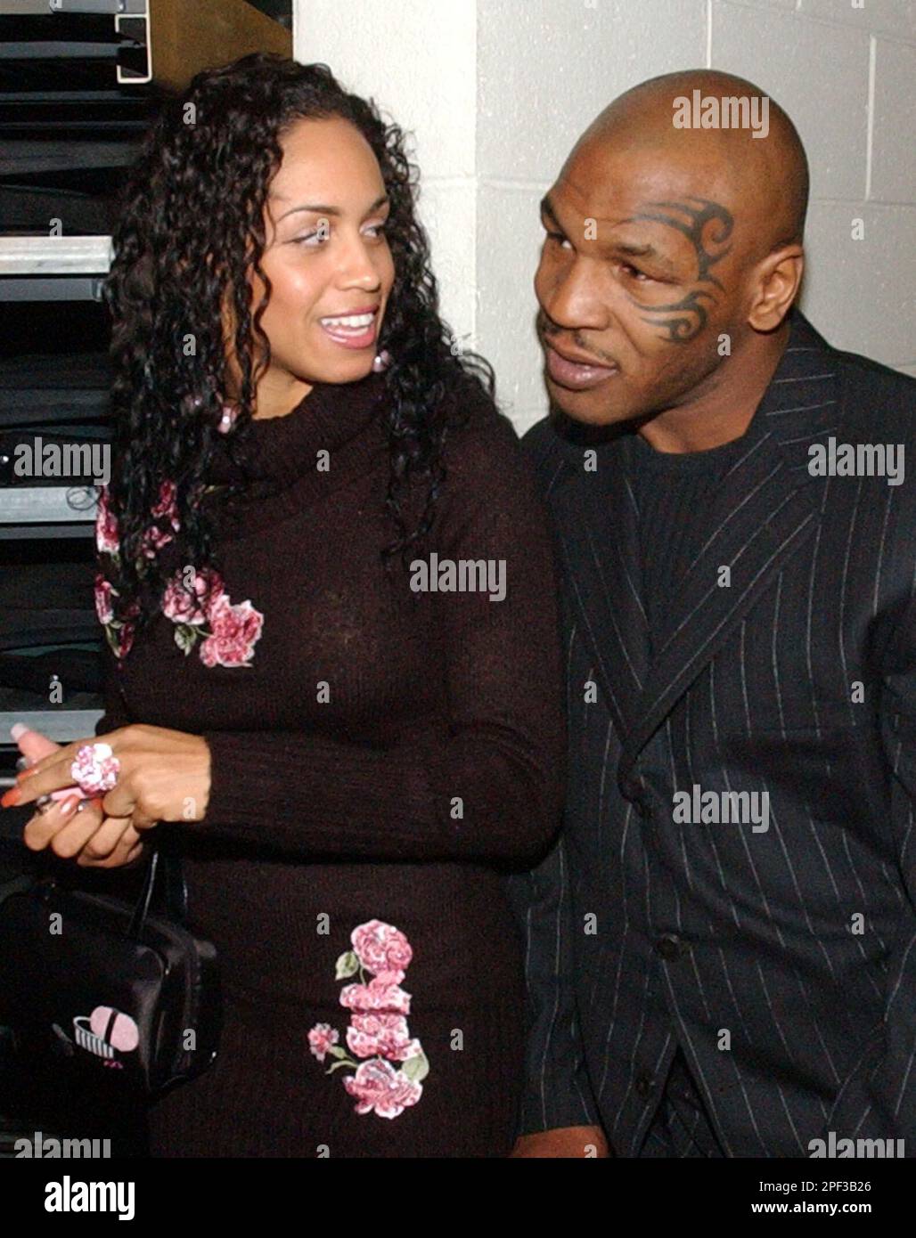 Actress Luz Whitney, left, talks with boxer Mike Tyson before the WBA ...