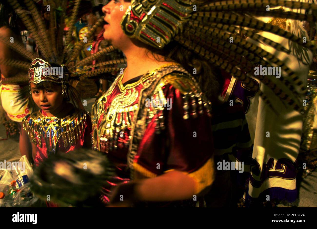 A Mexican indigenous woman dances a typical Aztec dance in the Basilica ...