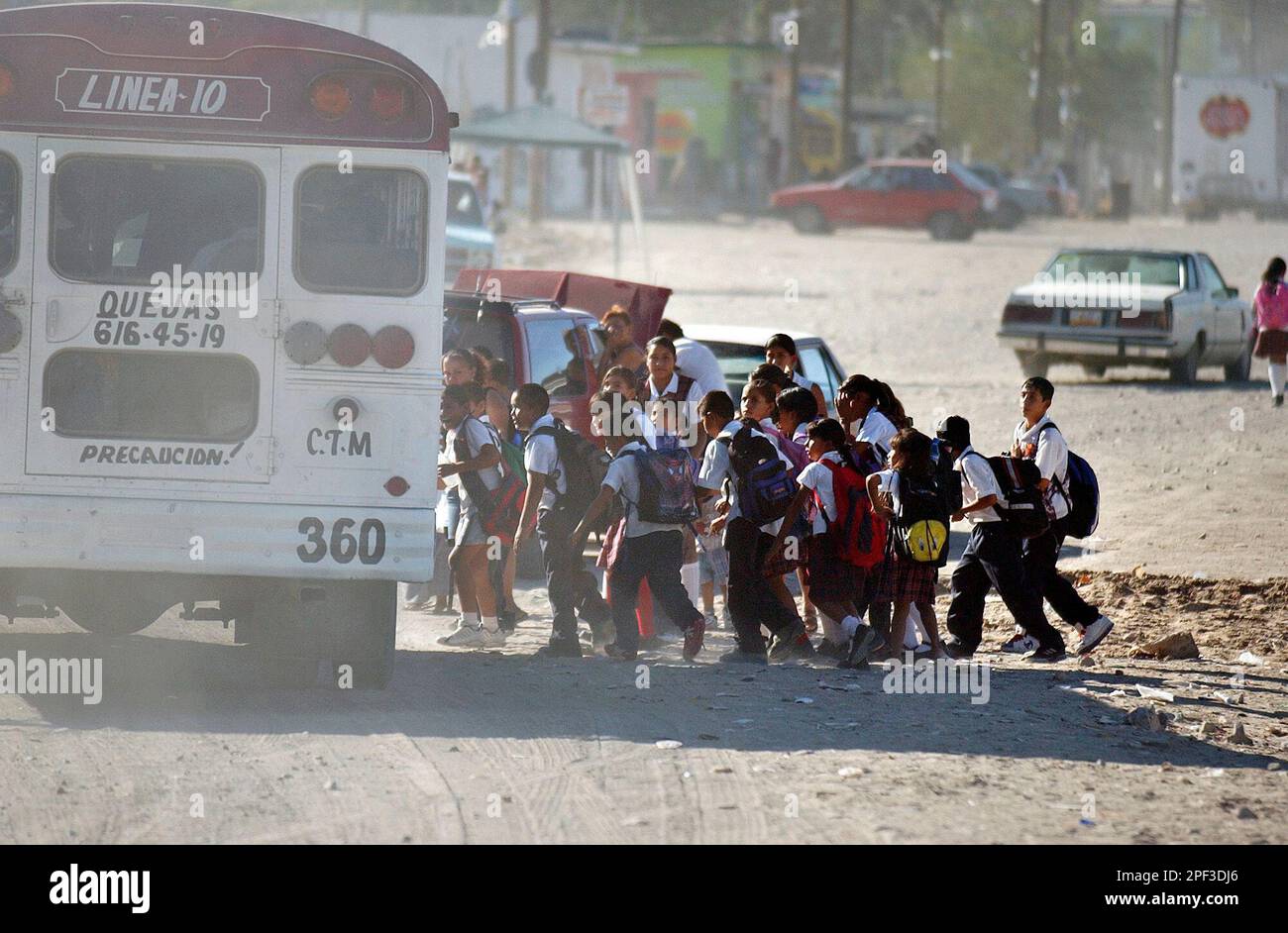 School children run to catch a bus after they finished their classes in ...