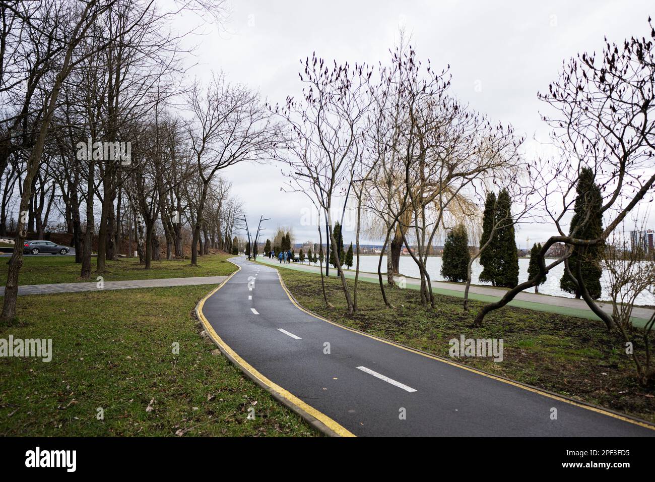 Running and cycling paths along the city alley embankment. Lake ...