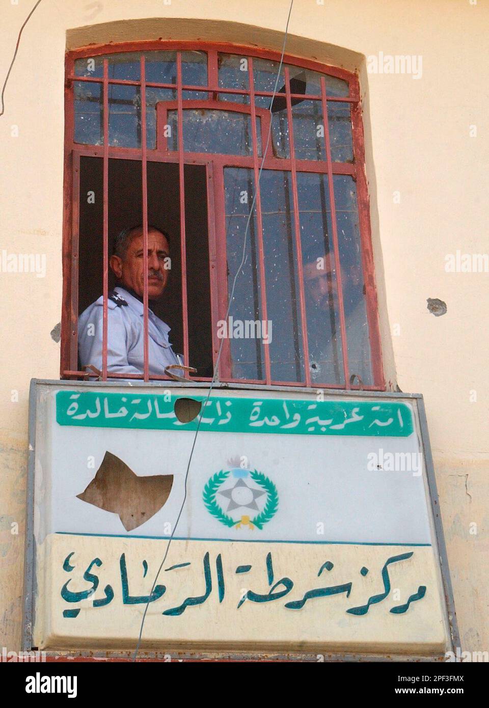 Chief of Ramadi police force Lt. Col. Hamid al-Alusi looks through a ...