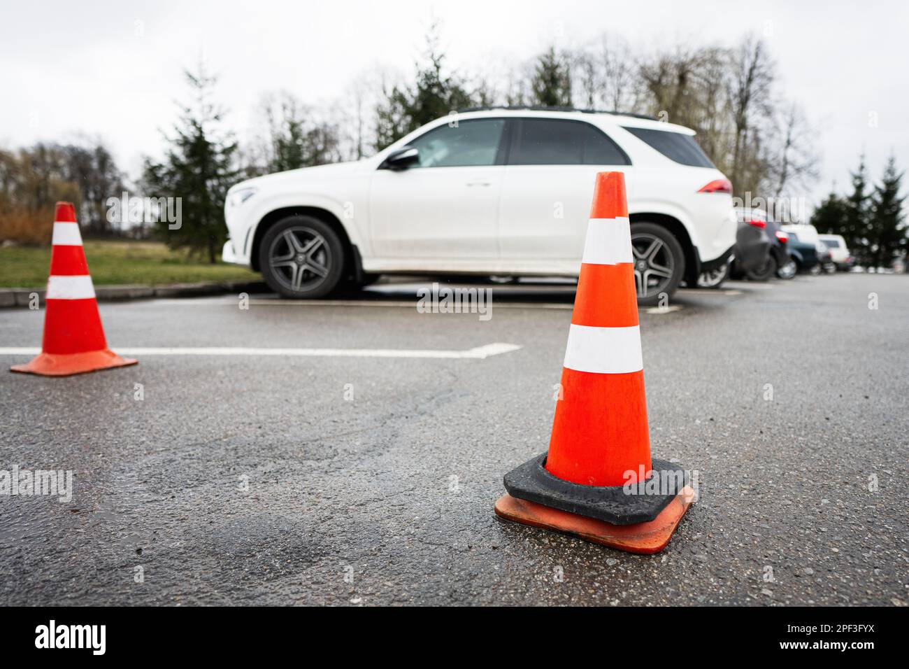 Traffic orange cones standing on a street along the parking cars Stock ...