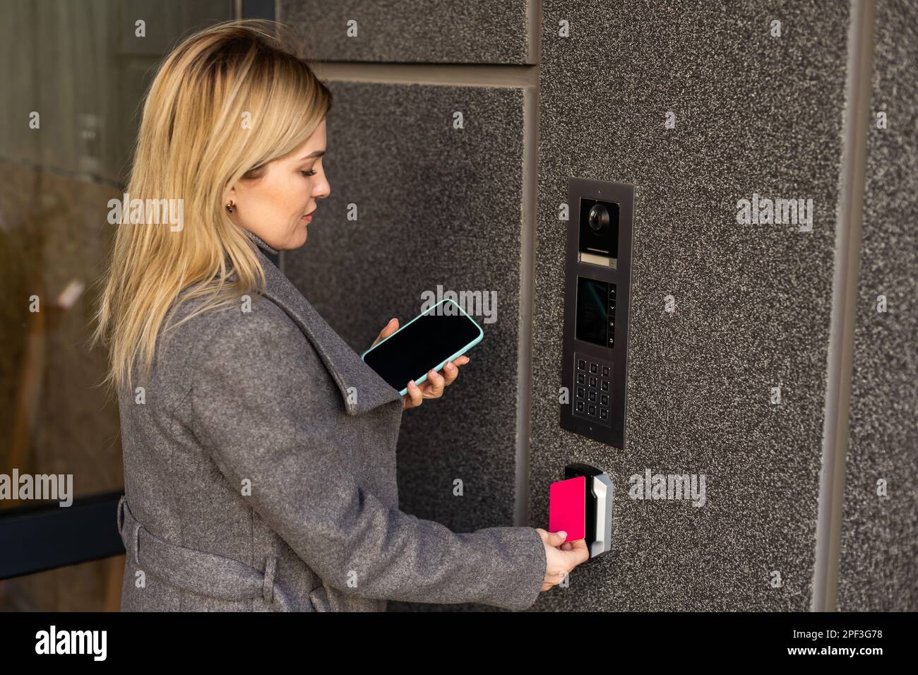 Close up of woman using card intercom at building entrance Stock Photo ...