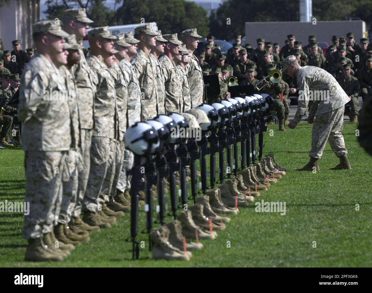 Marines stand at attention near 15 boots representing the 15 Marines ...
