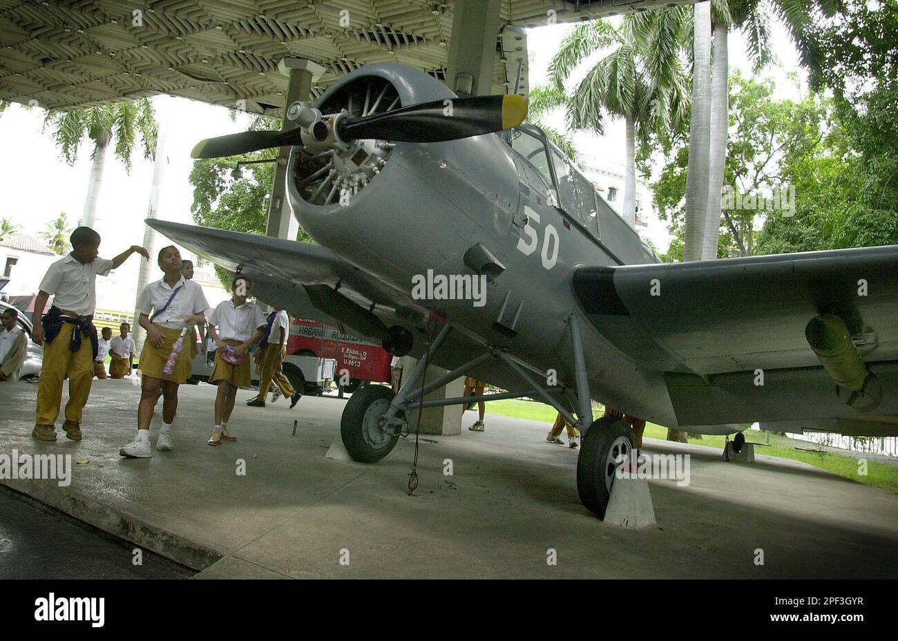 Cuban students observe the aircraft King Fisher, an airplane used by ...