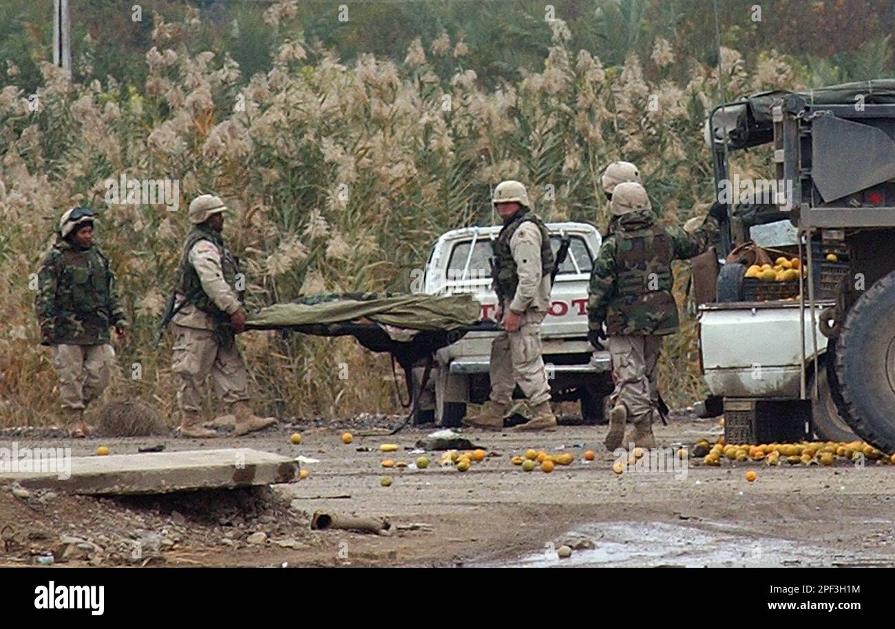 U.S. Army soldiers remove the body of a killed comrade after an ambush ...