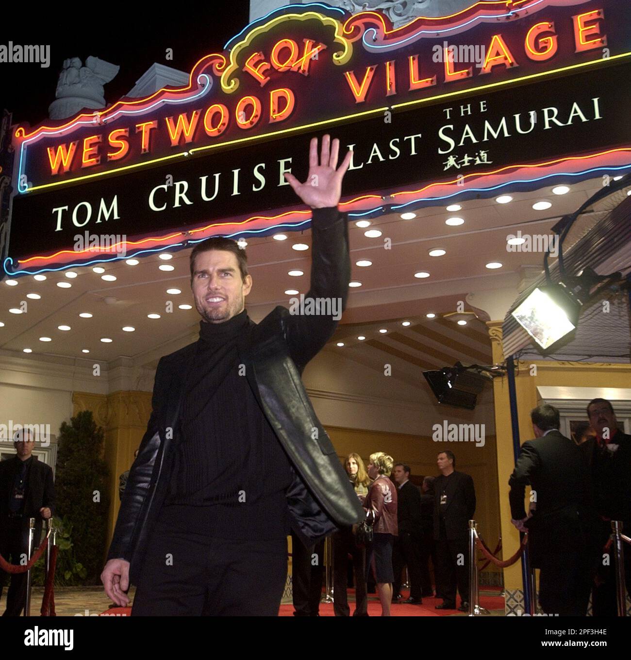Tom Cruise, star of the new film "The Last Samurai," waves to fans as ...