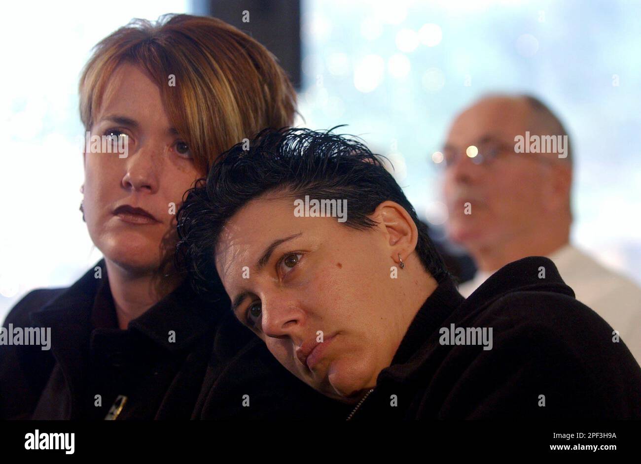 Wendi Deetz, left, and Gina Belleci listen to a sermon during a ...