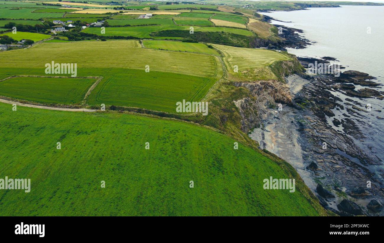 Rocky coast. Green farm fields on the Atlantic Ocean. Seaside Irish ...