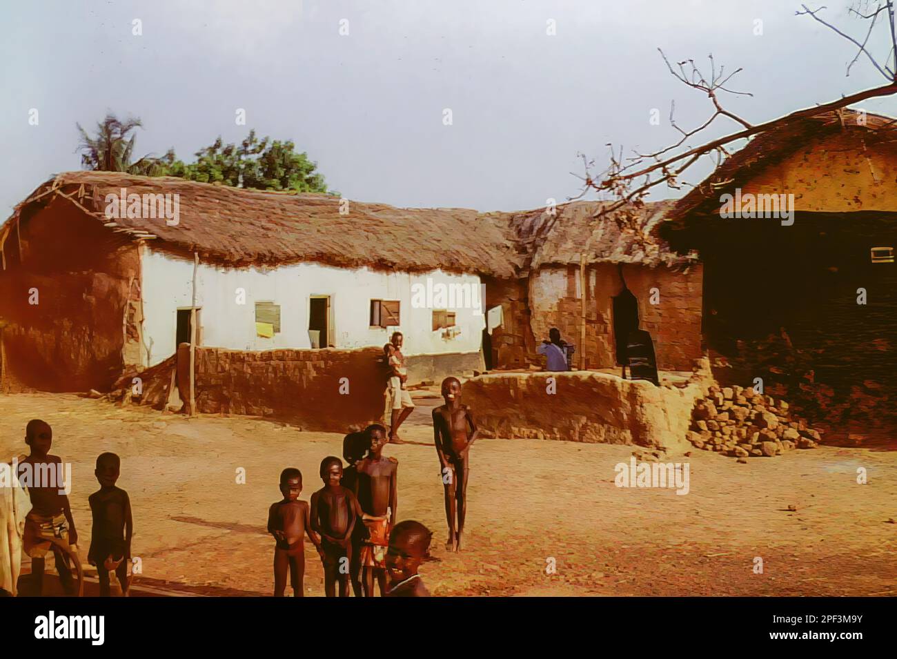 A group of African children near a house in Yendi, Ghana c.1959 Stock ...