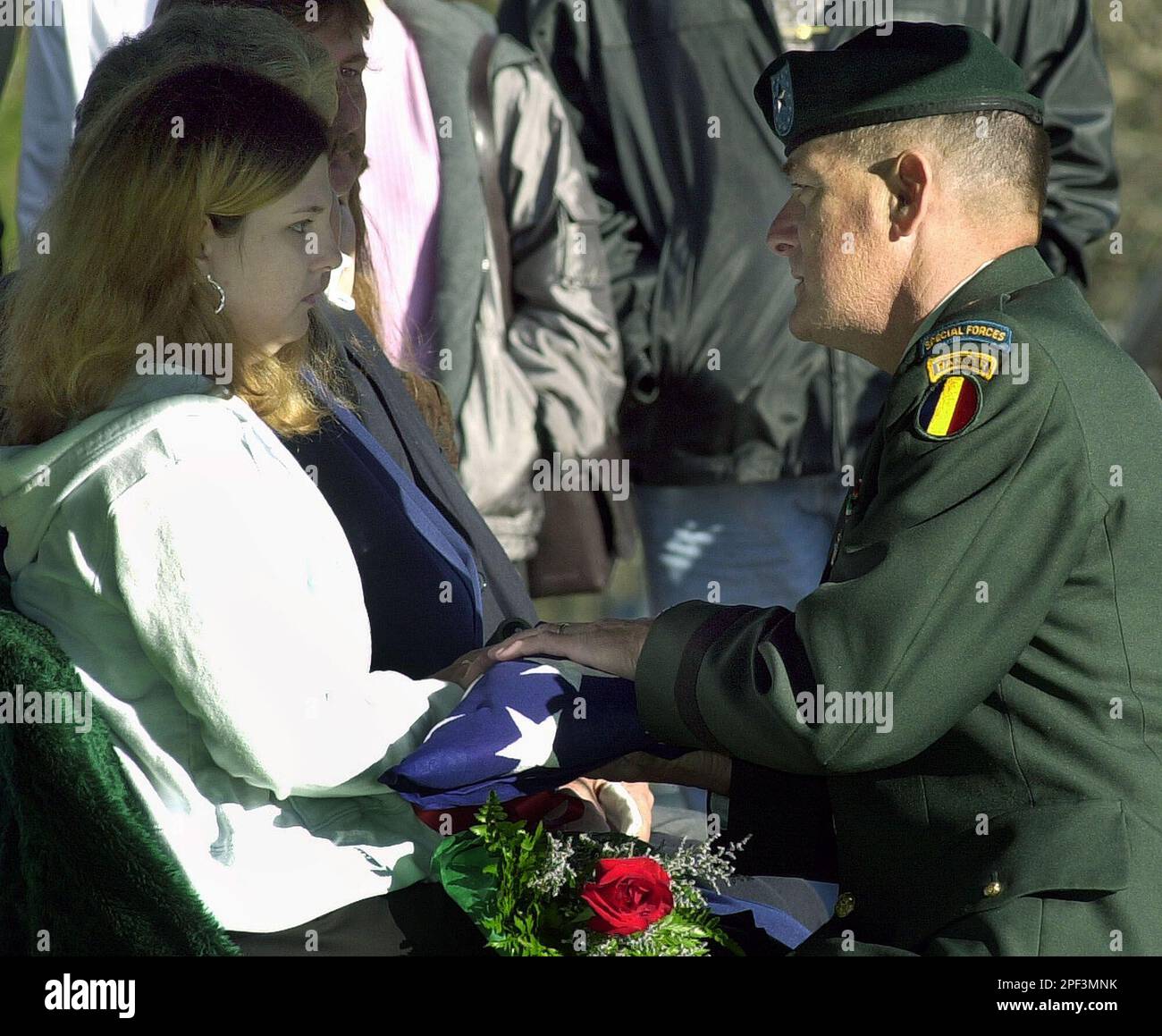 Army Brig. Gen. Leslie Fuller presents Beth Whitener with a flag at a ...