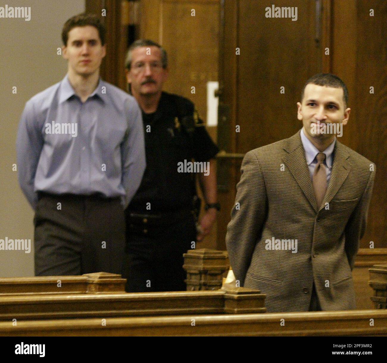 Sebastian Burns, left, and Atif Rafay, right, are led into a King ...