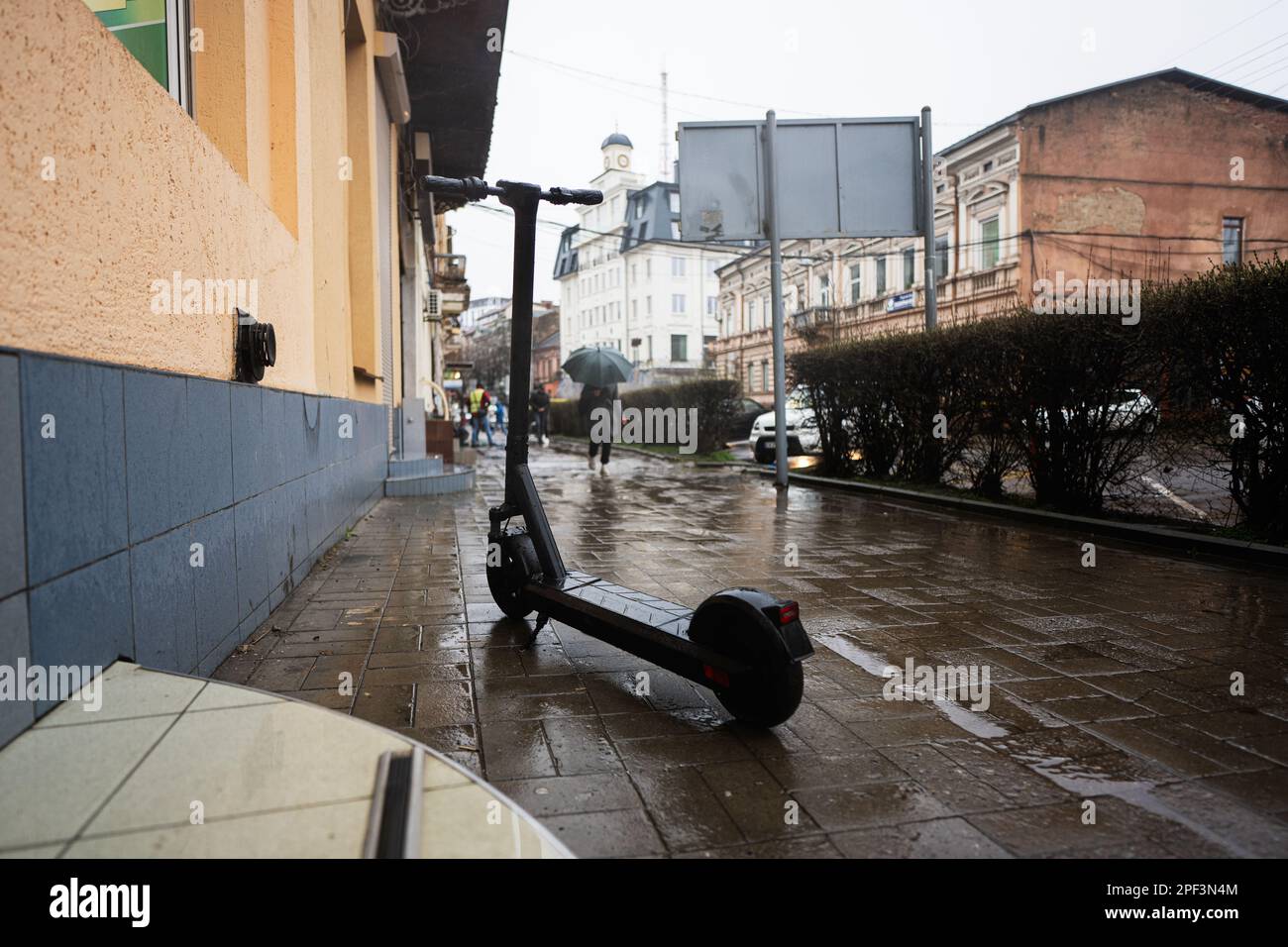 Electric scooter stand in rain city street Stock Photo - Alamy