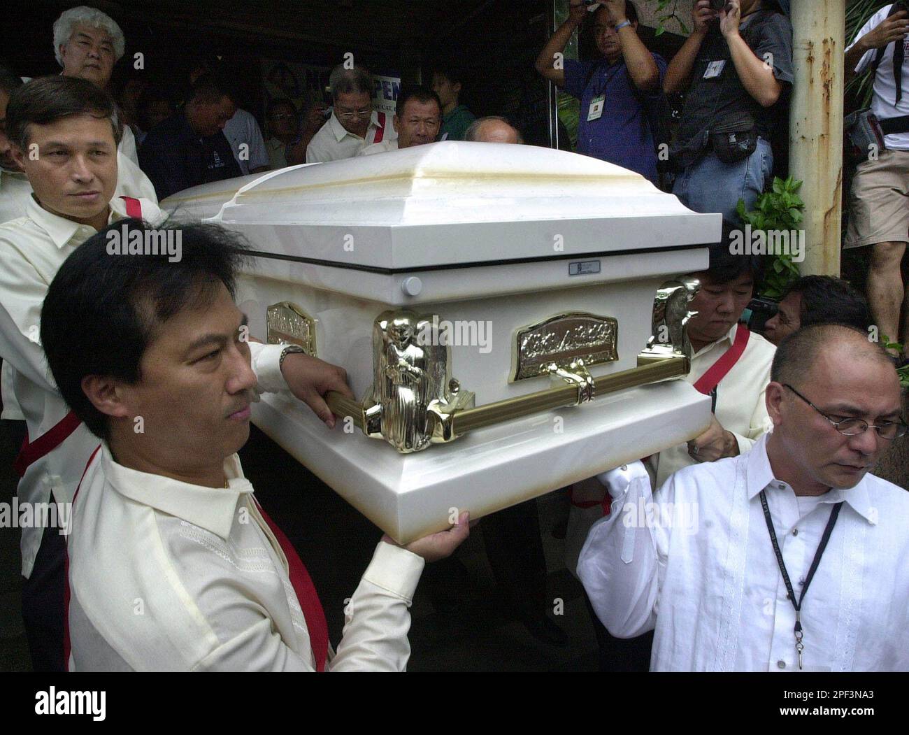 Mourners carry the casket of kidnap victim Betti Chua Sy during a ...
