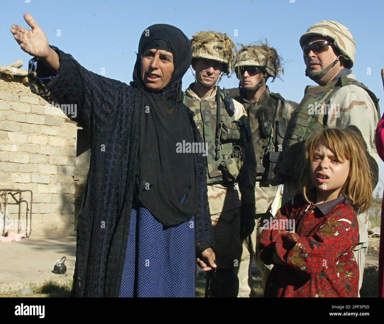An Iraqi woman shows soldiers of the U.S. Army's 4th Infantry Division ...