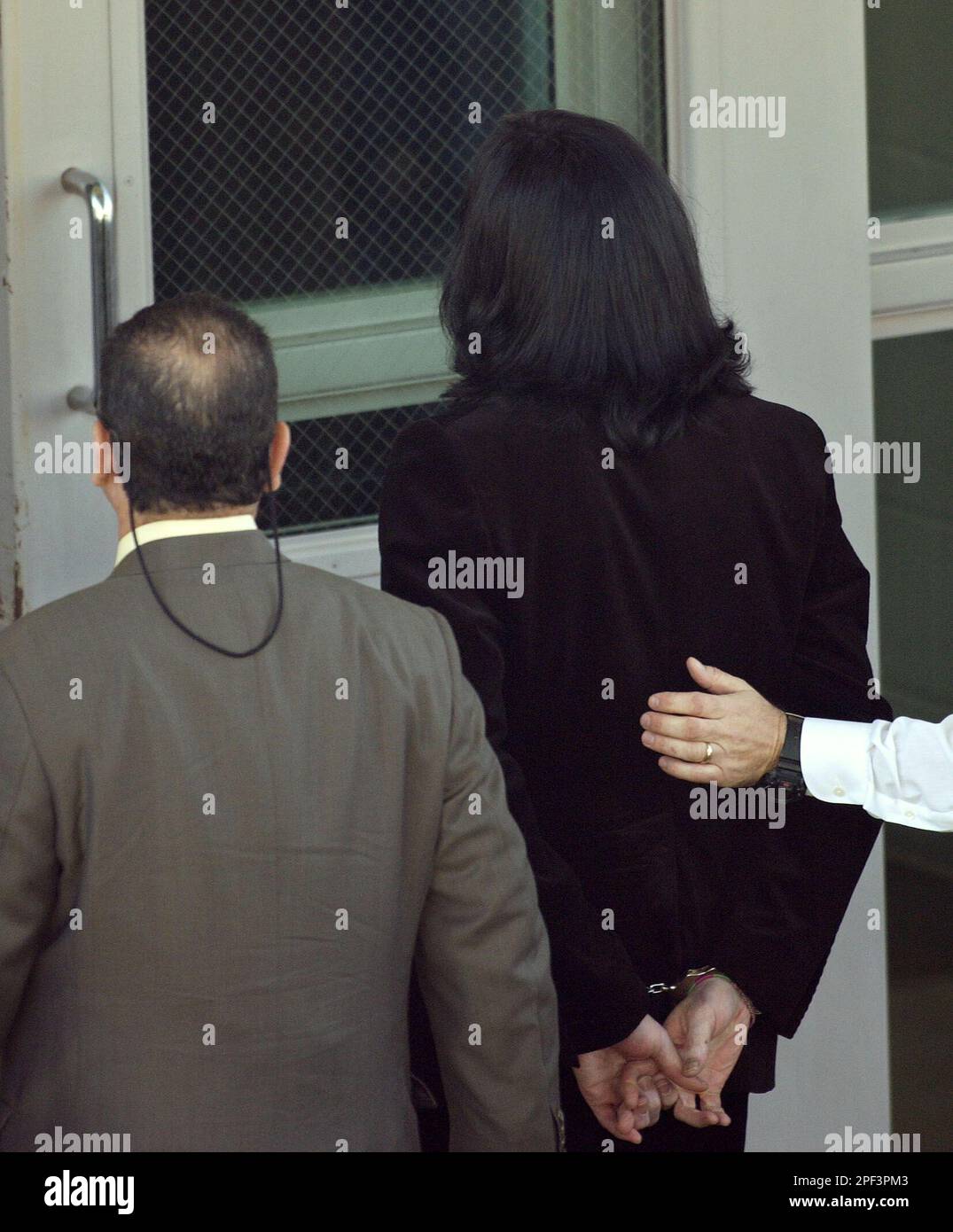 Michael Jackson is taken into the Santa Barbara County Jail facility to ...