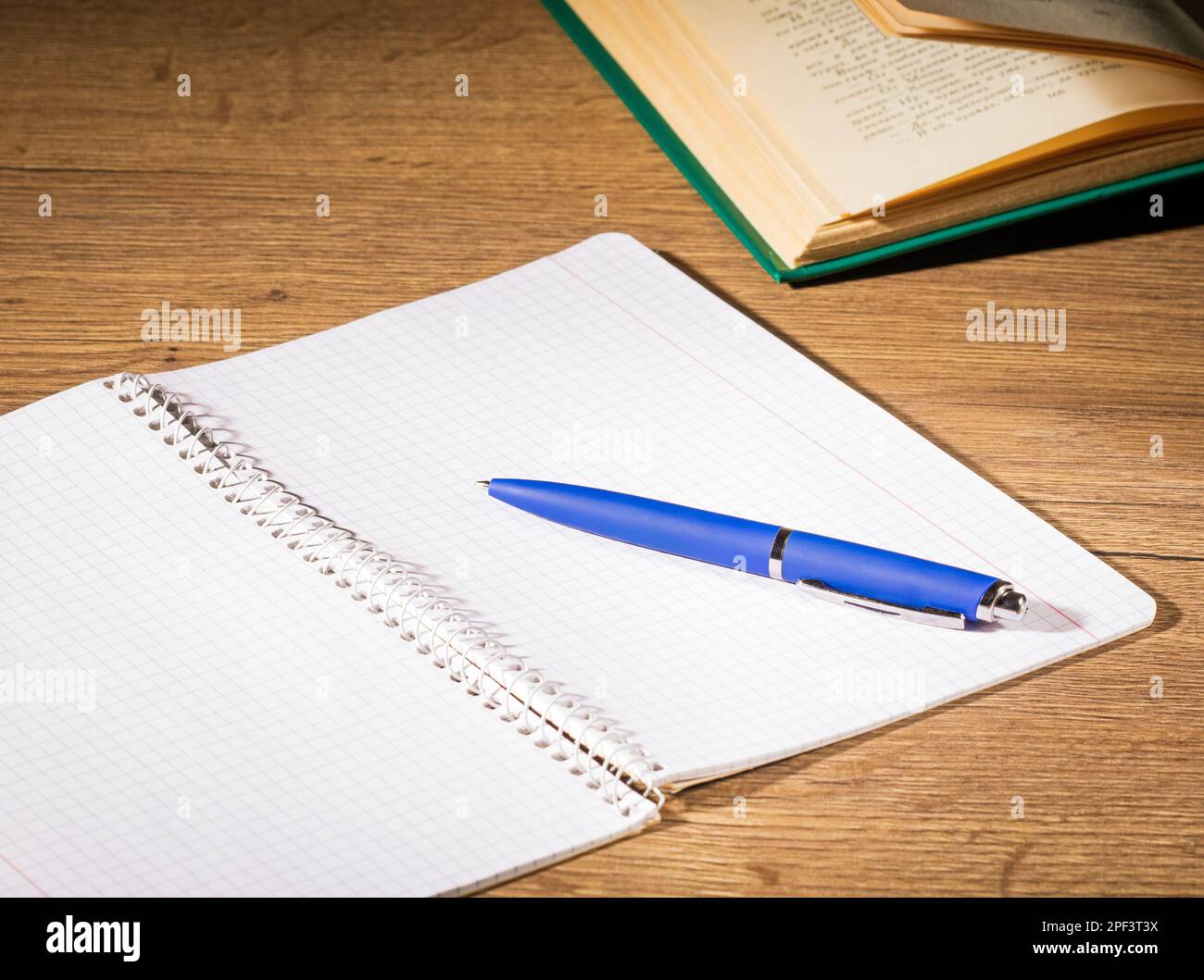 An open notebook with a pen lying on it prepared for writing on the ...