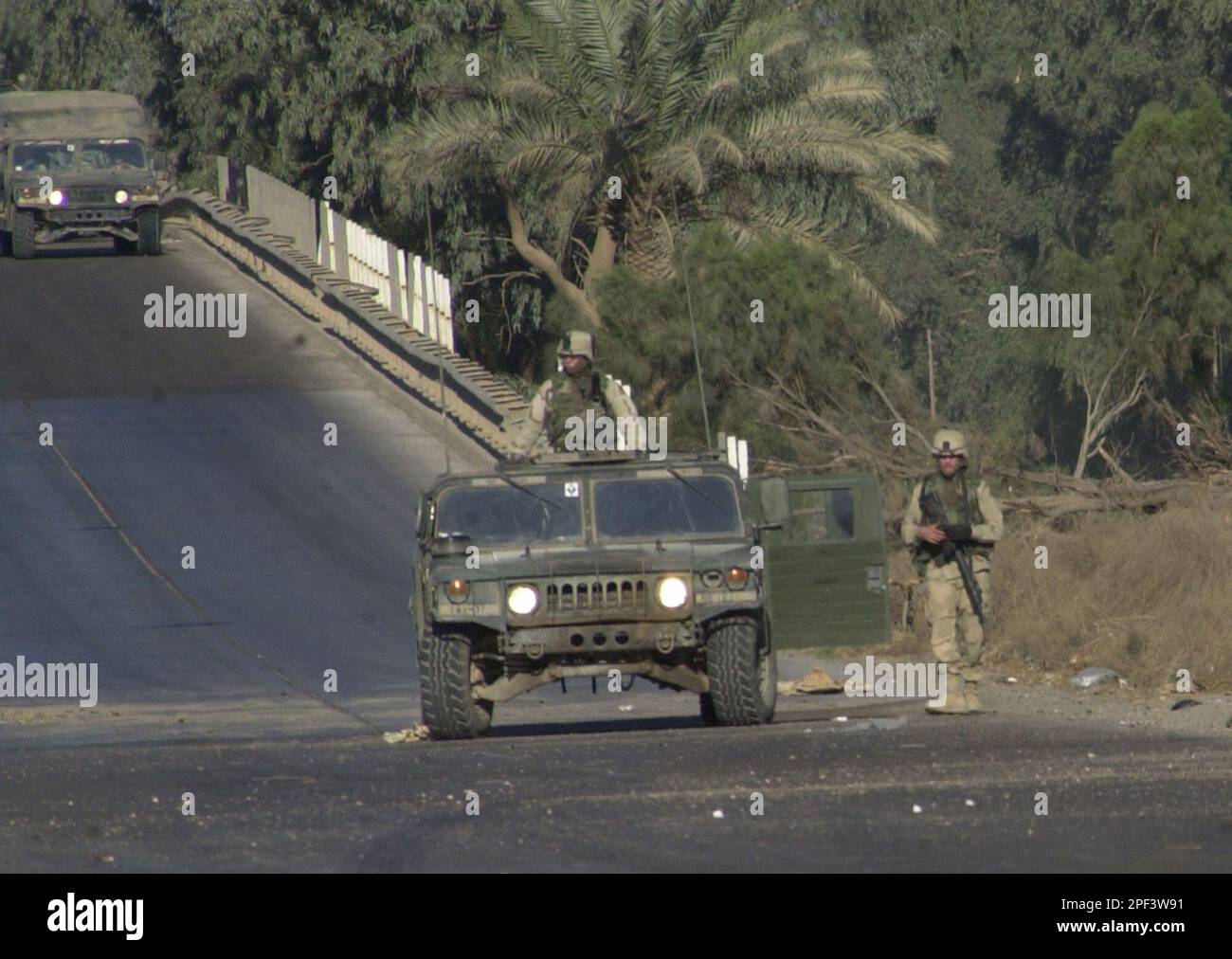 US Army soldiers block the road in Baghdad, Saturday Nov. 15, 2003 ...