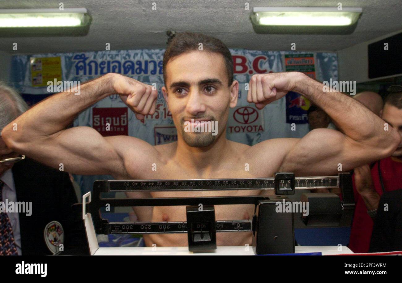Australian challenger Hussein Hussein flexes his muscles during a weigh ...