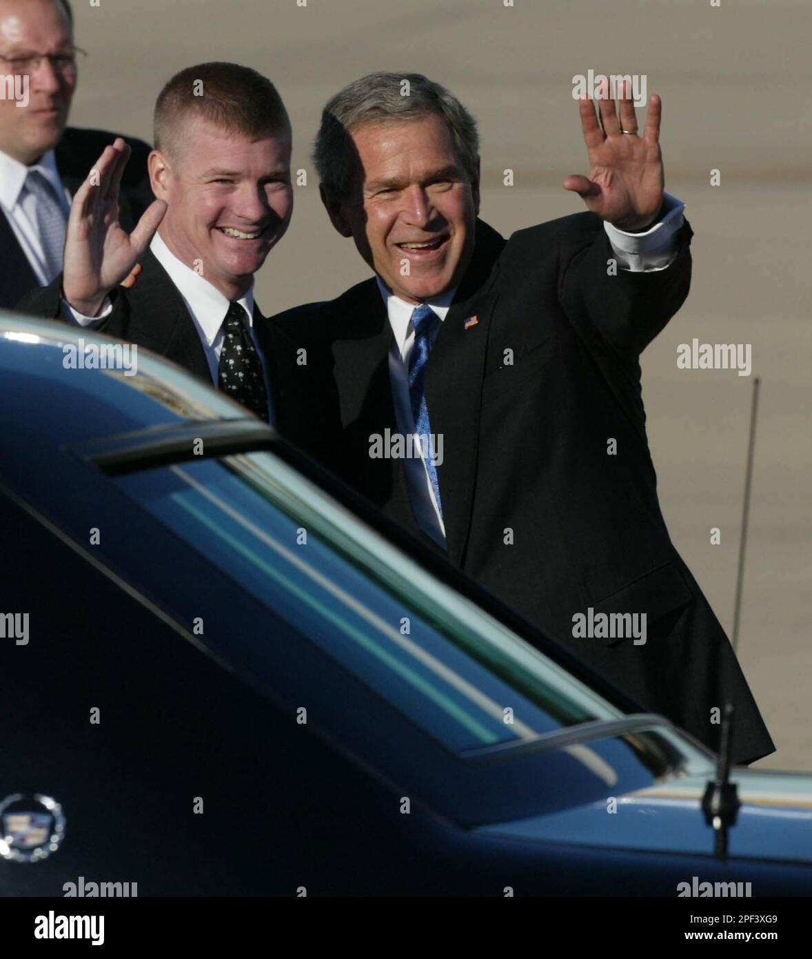 President George W. Bush waves at the crowd with Air Force Major Greg ...