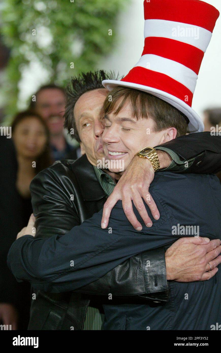 Actor Mike Myers gets a hug from producer Brian Grazer as they arrive ...