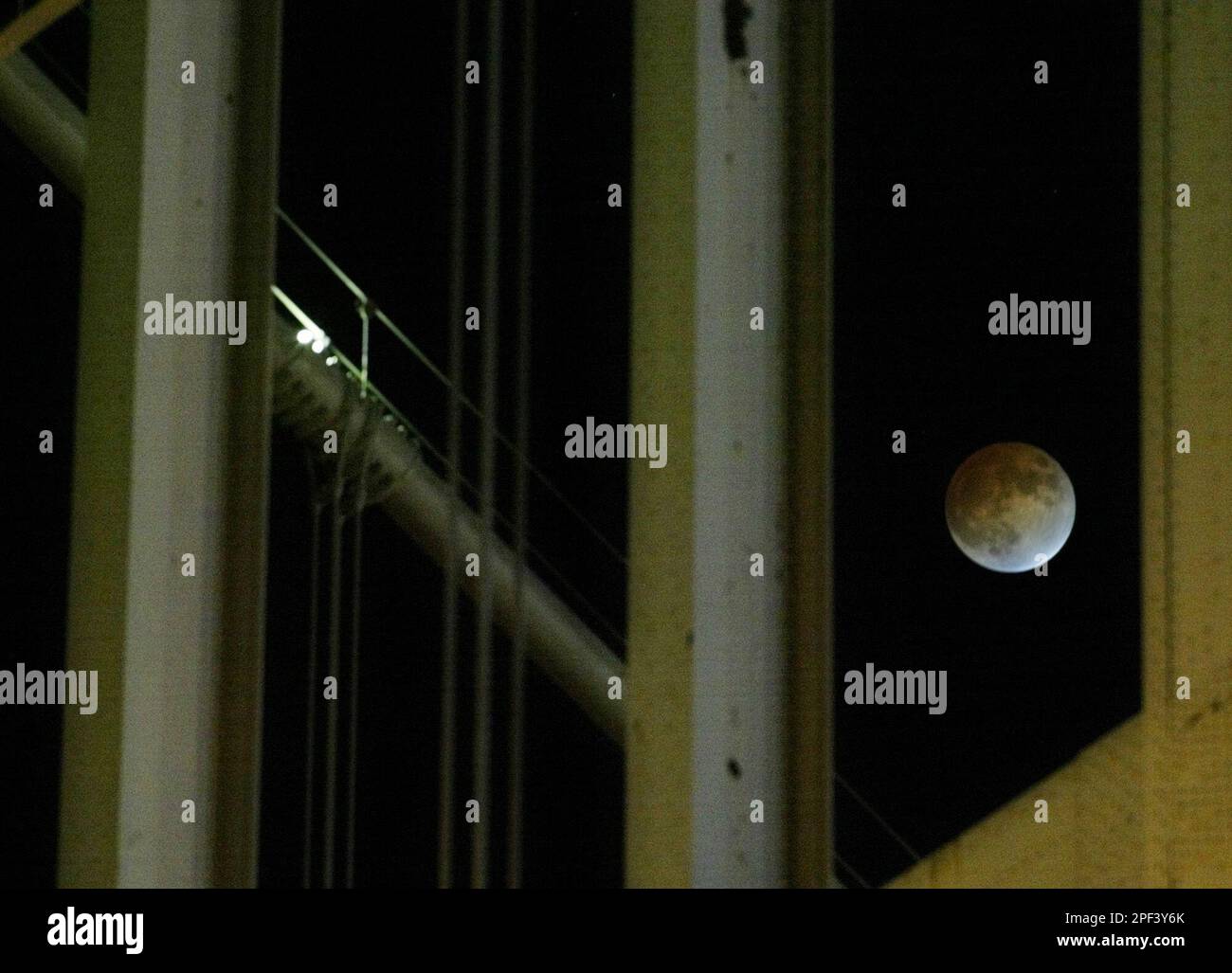 The moon is shown during the total lunar eclipse as it rises above the ...