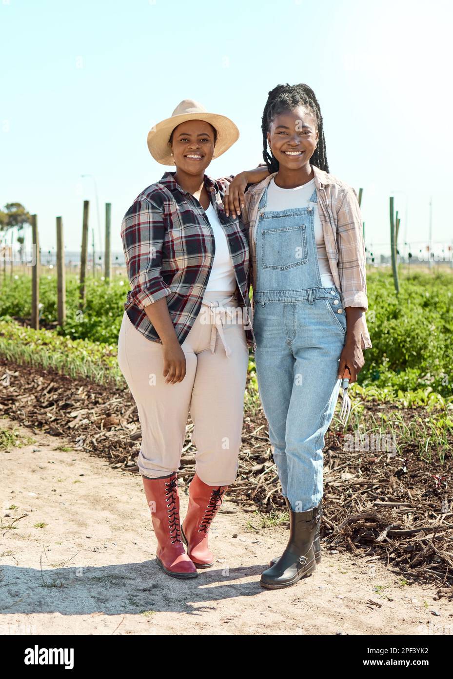 Two farmers embracing. Portrait of two happy farmers. Farmers standing in their garden. Smiling ...