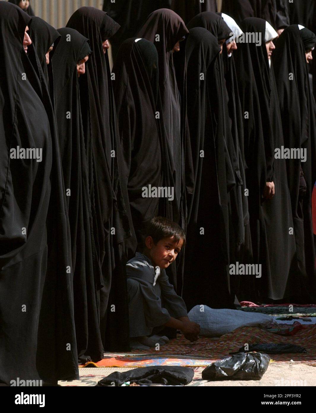 Iraqi women line up as they pray during a sermon of the Shiite Muslim ...