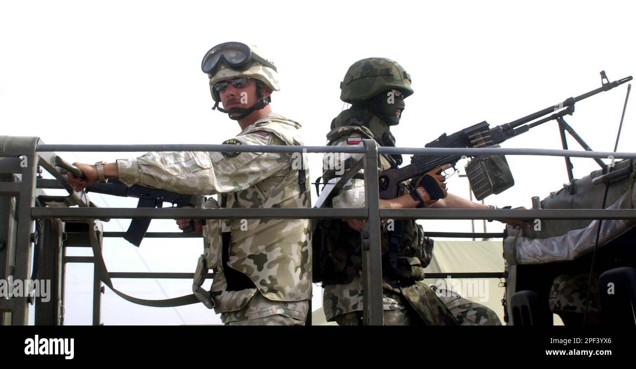 Two Polish soldiers hold their guns as they patrol the streets of the ...